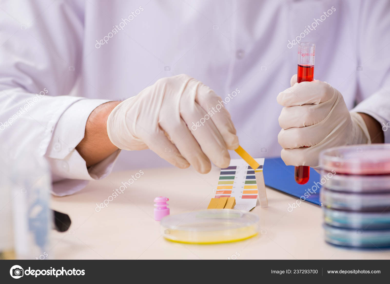 Chemist in the lab checking with ph strips — Stock Photo © Elnur ...