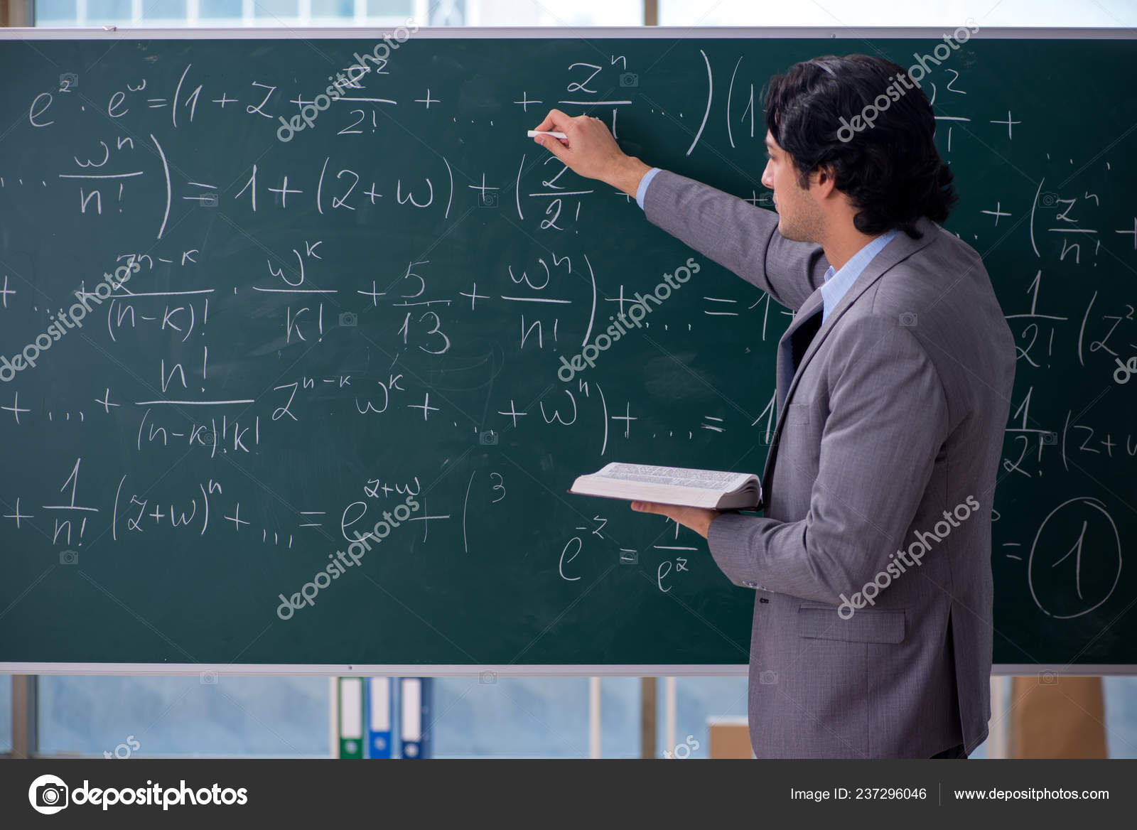 Young handsome math teacher in classroom — Stock Photo © Elnur_ #237296046