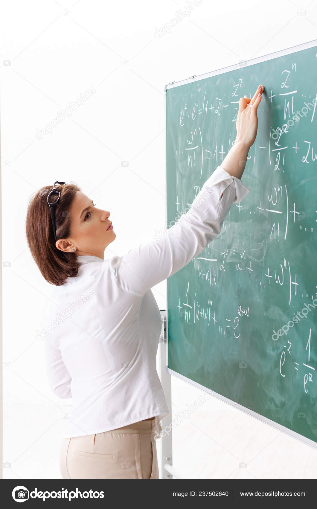 Female math teacher in front of the chalkboard — Stock Photo © Elnur ...