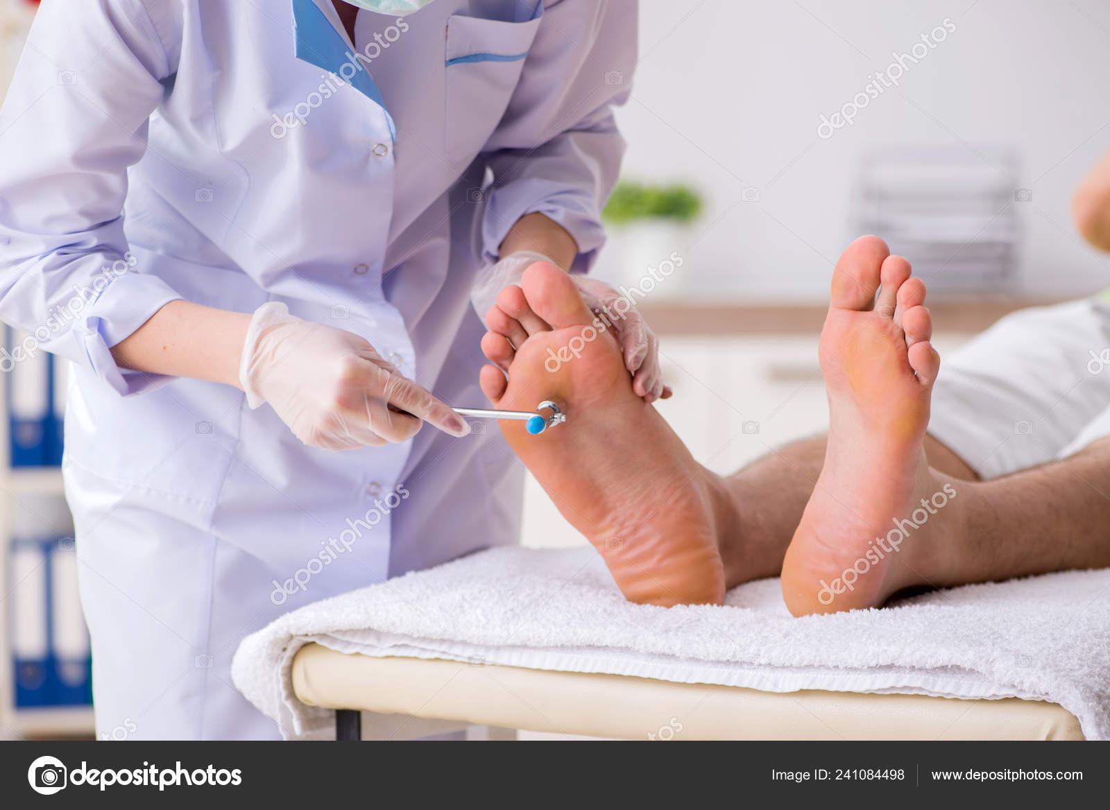 Podiatrist treating feet during procedure Stock Photo by ©Elnur_ 241084498