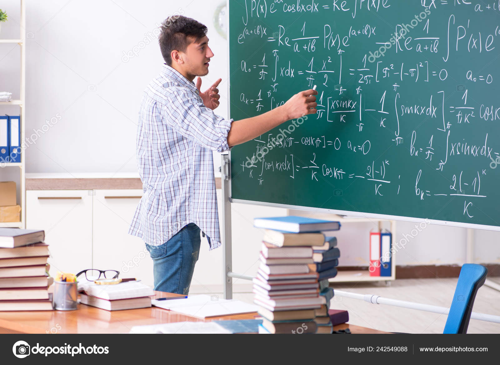 Young male student studying math at school Stock Photo by ©Elnur_ 242549088