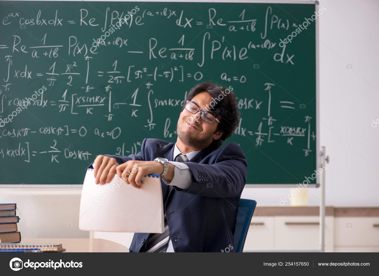Young male math teacher in classroom — Stock Photo © Elnur_ #254157650