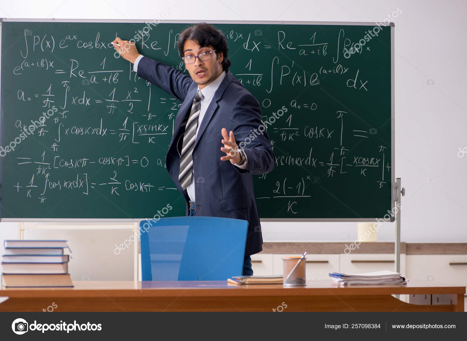 Young male math teacher in classroom — Stock Photo © Elnur_ #257098384