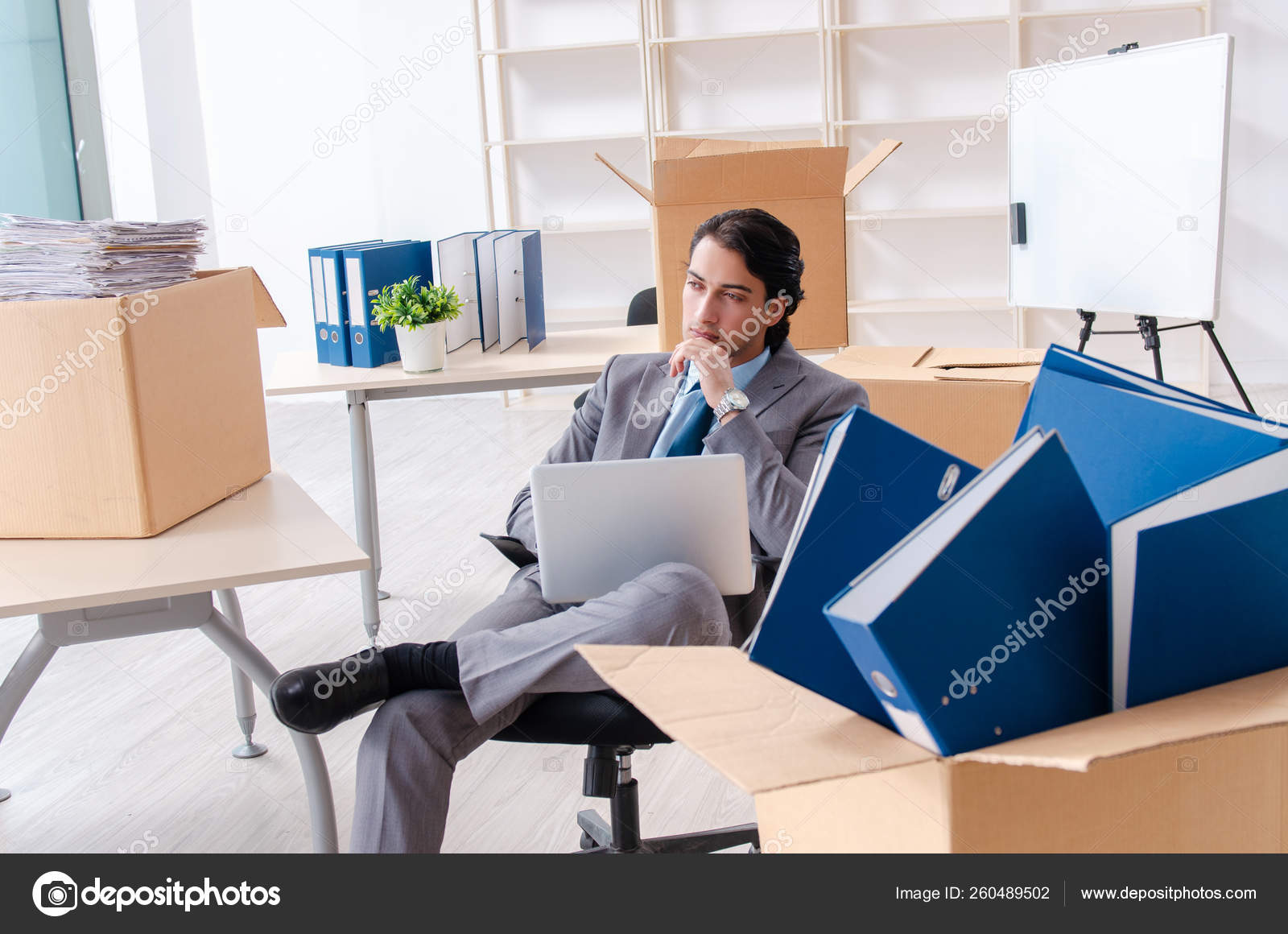 Young man employee with boxes in the office Stock Photo by ©Elnur ...
