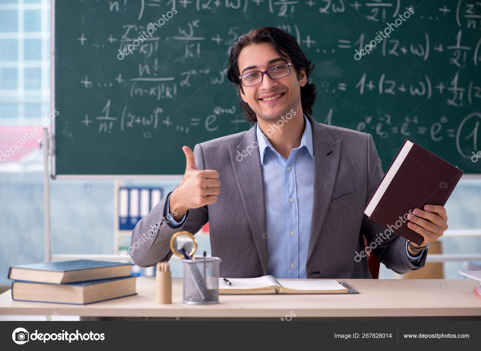 Young handsome math teacher in classroom — Stock Photo © Elnur_ #267828014