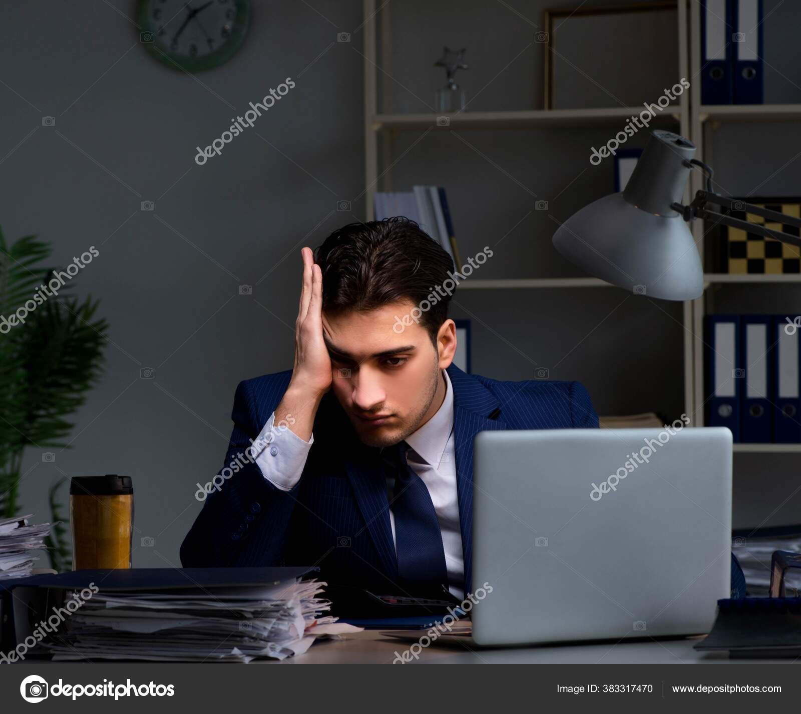 Employee working late to finish important deliverable task Stock Photo ...