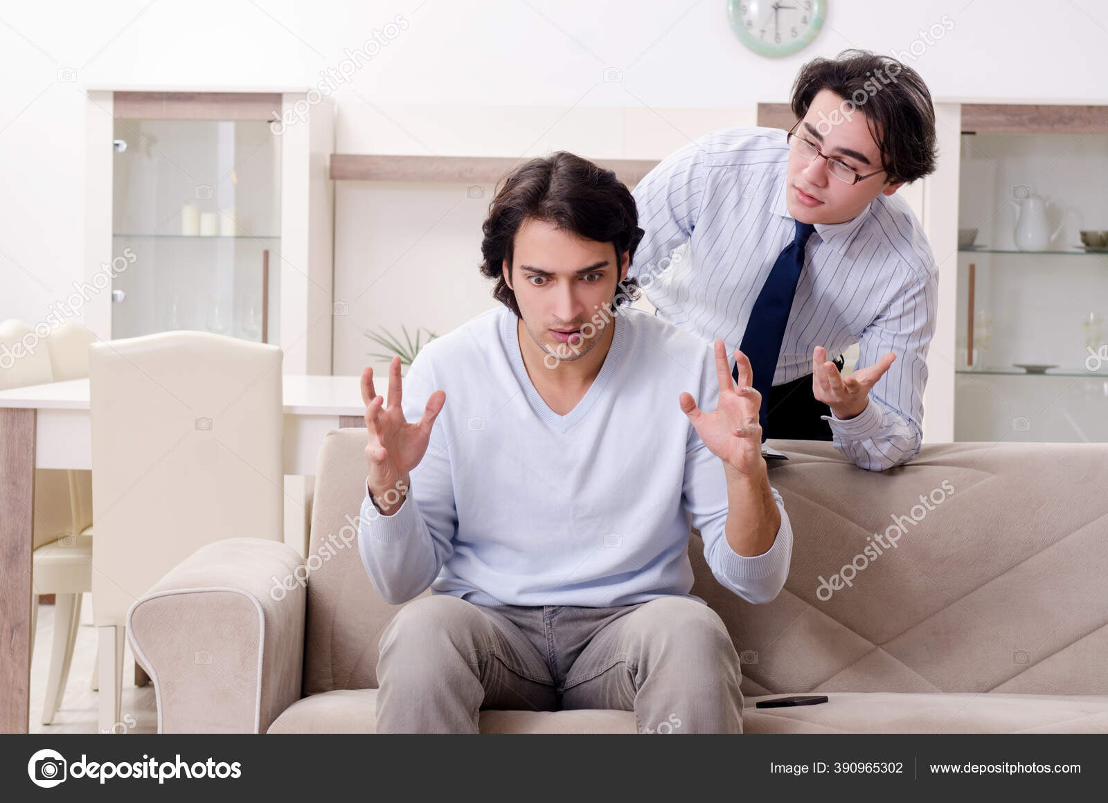 Young male patient discussing with psychologist personal problem ...