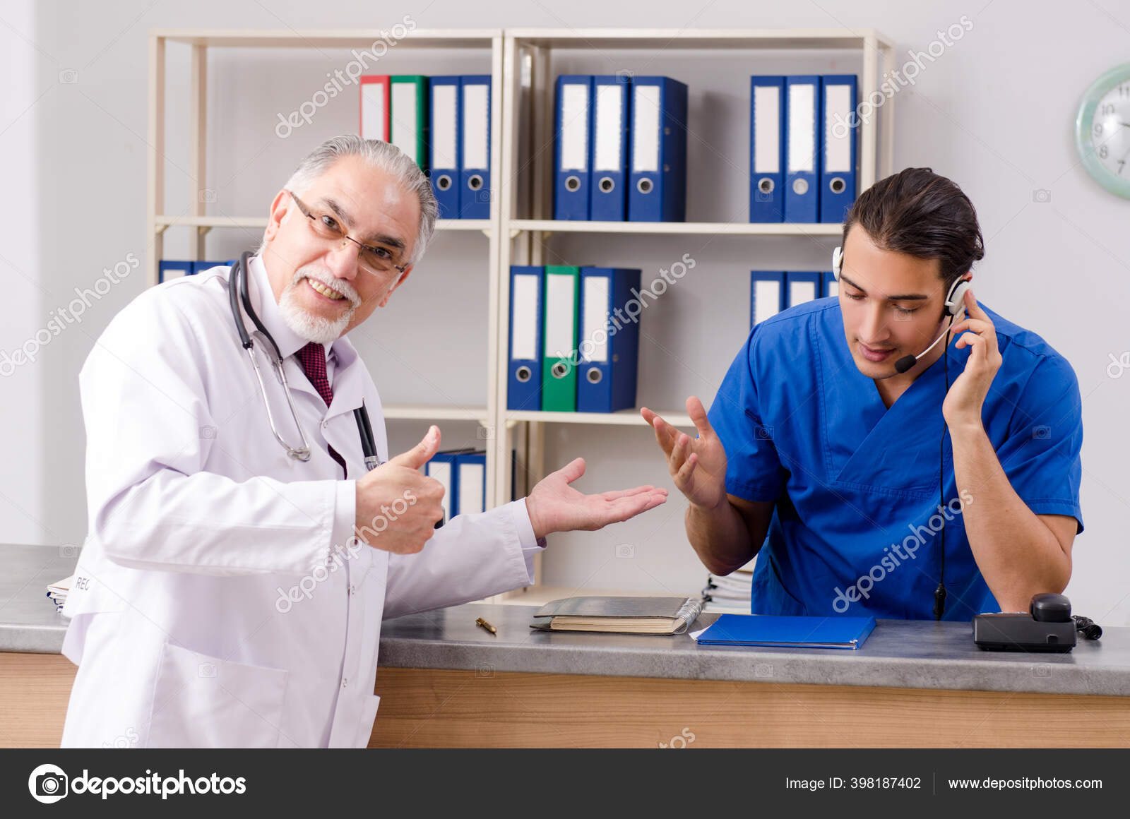 Two doctors talking at the reception in hospital — Stock Photo © Elnur ...