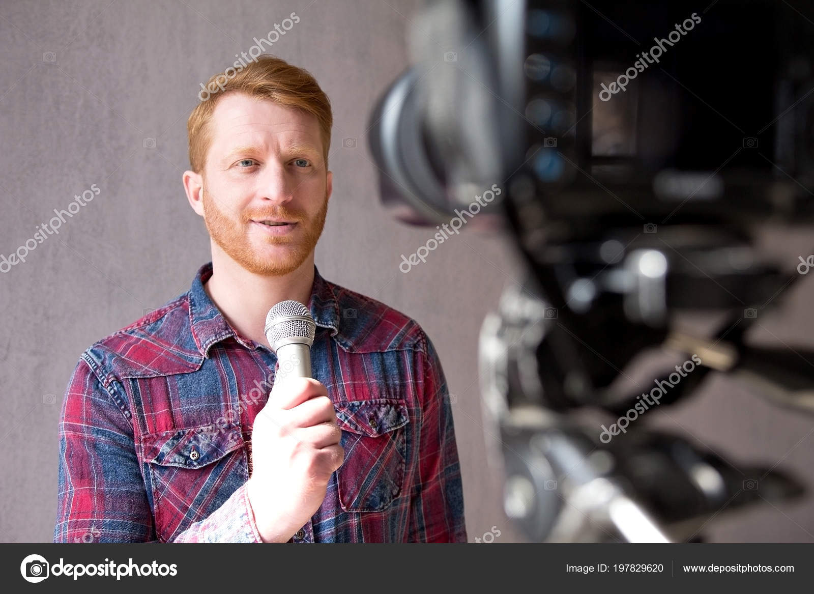 Attractive man with microphone in front of camera. — Stock Photo ...
