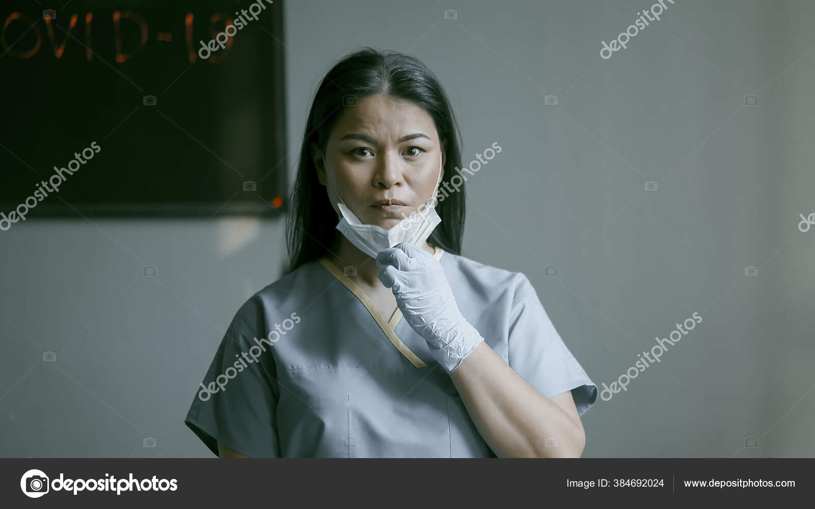 Beautiful Asian woman opened her face by removing her face mask and ...