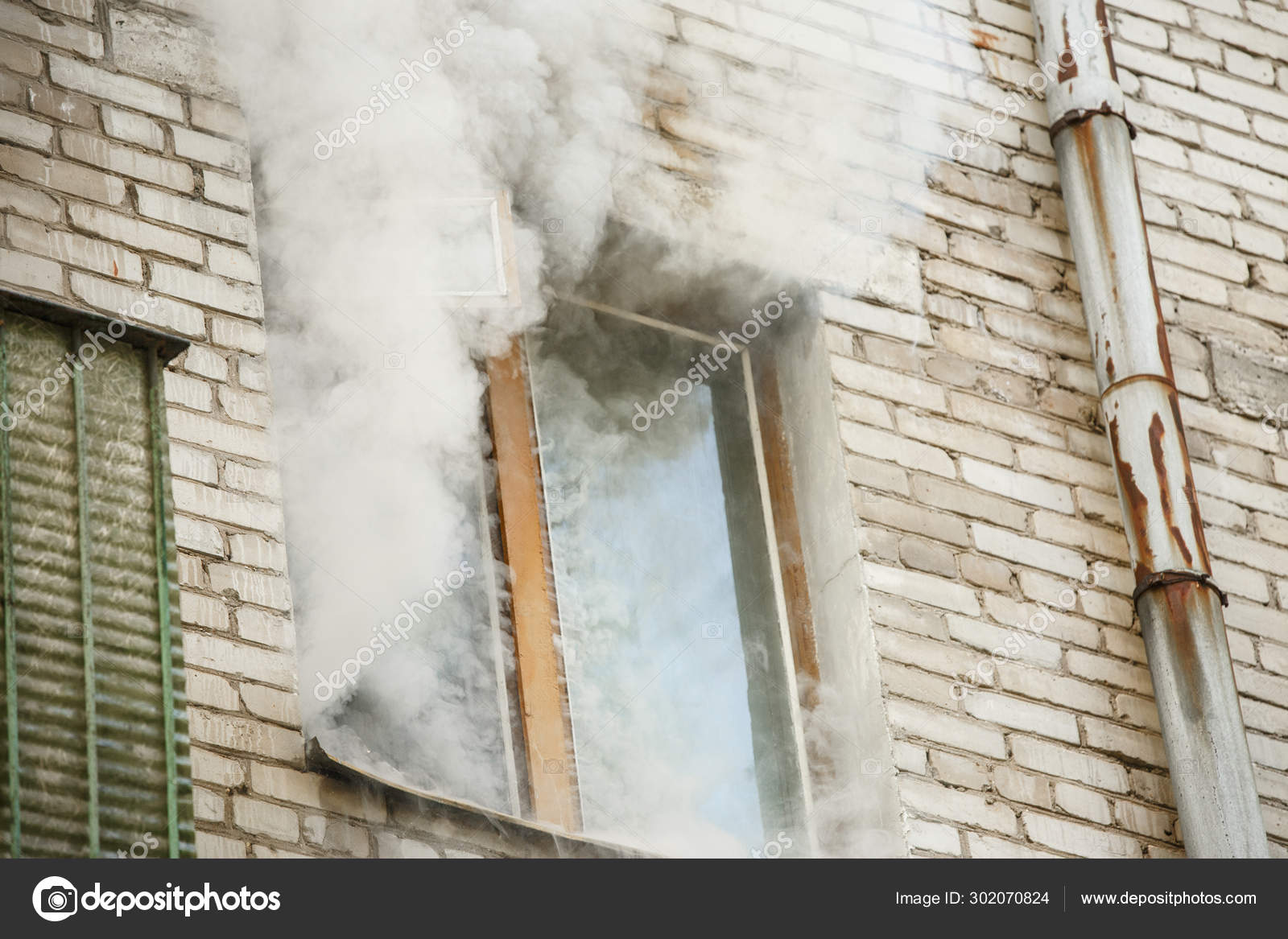 Image of brick house with smoke coming out of window — Stock Photo ...