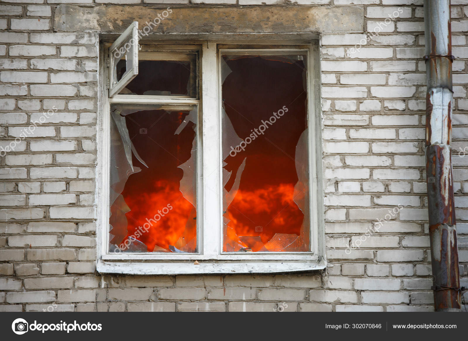 Image of brick house with with fire in window. — Stock Photo © logoff ...