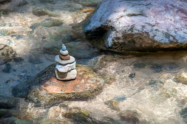 Pile of stones along a creek. Stacked rocks - Stock Image - Everypixel