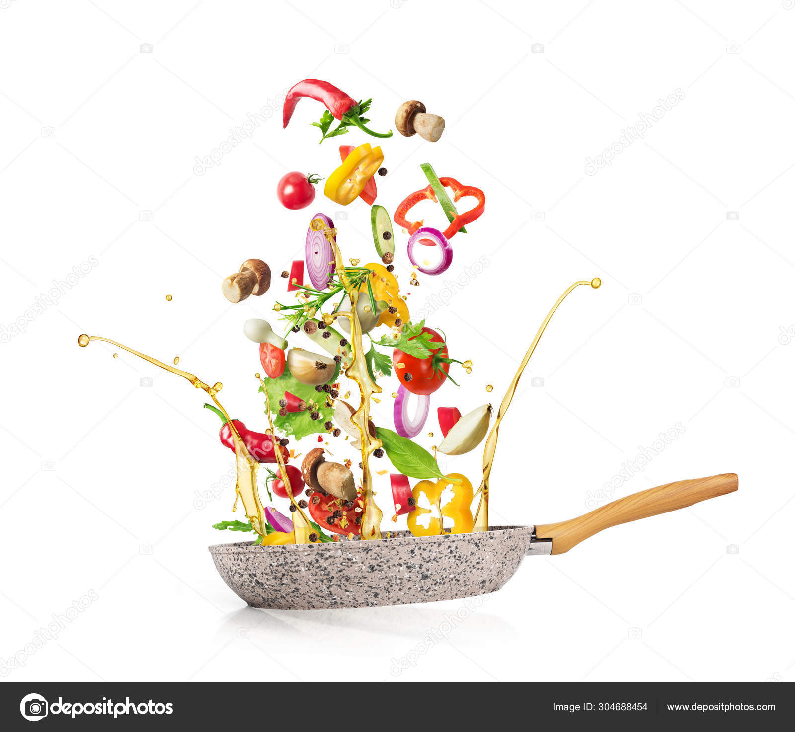 Cooking concept. Vegetables are flying out of the pan isolated o ...