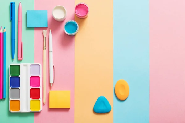 School supplies at colorful paper background texture Stock Photo by ...