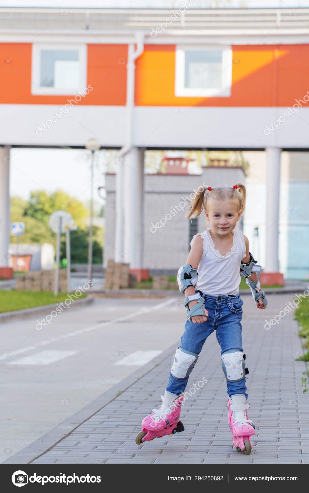 Little girl rides inline skates — Stock Photo © Kruchenkova #294250892