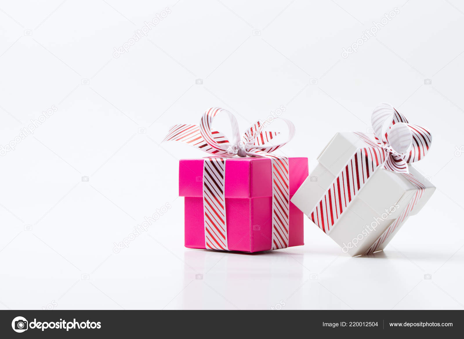 Pink and white gift box tied with white red stripe ribbon Stock Photo ...