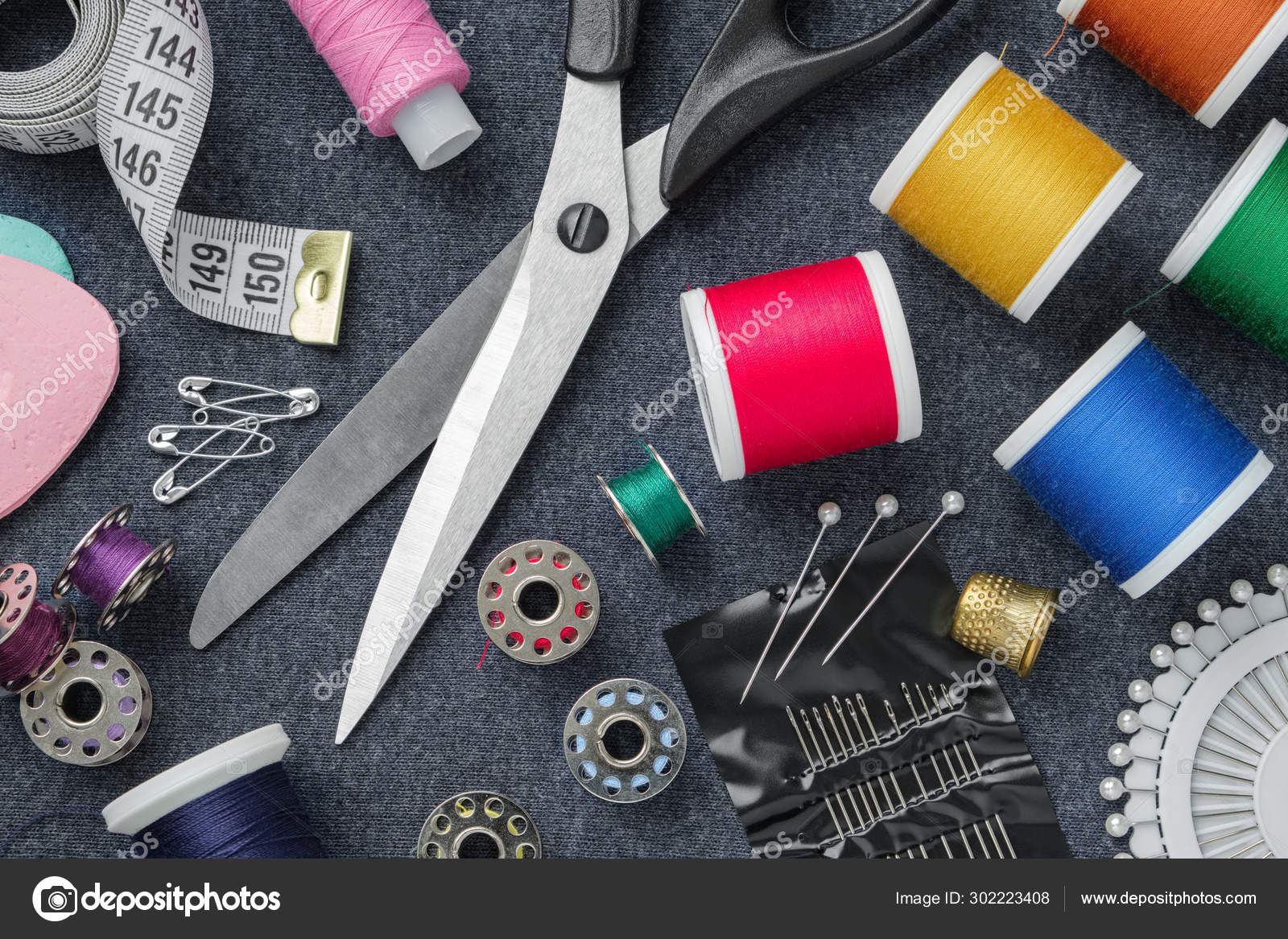 Sewing items: tailoring scissors; measuring tape; thimble; spools of ...