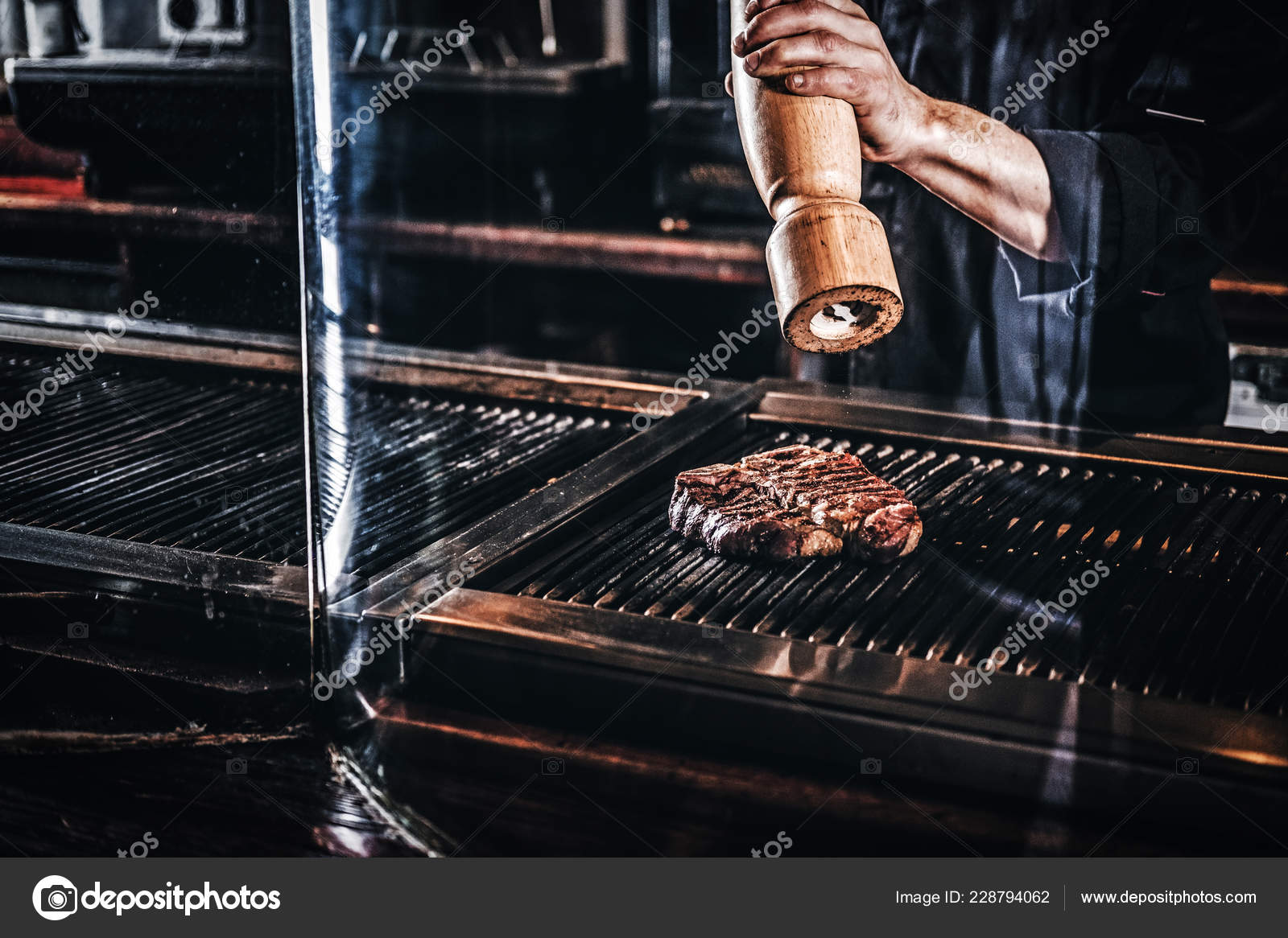 Master chef wearing uniform cooking delicious beef steak on a kitchen ...