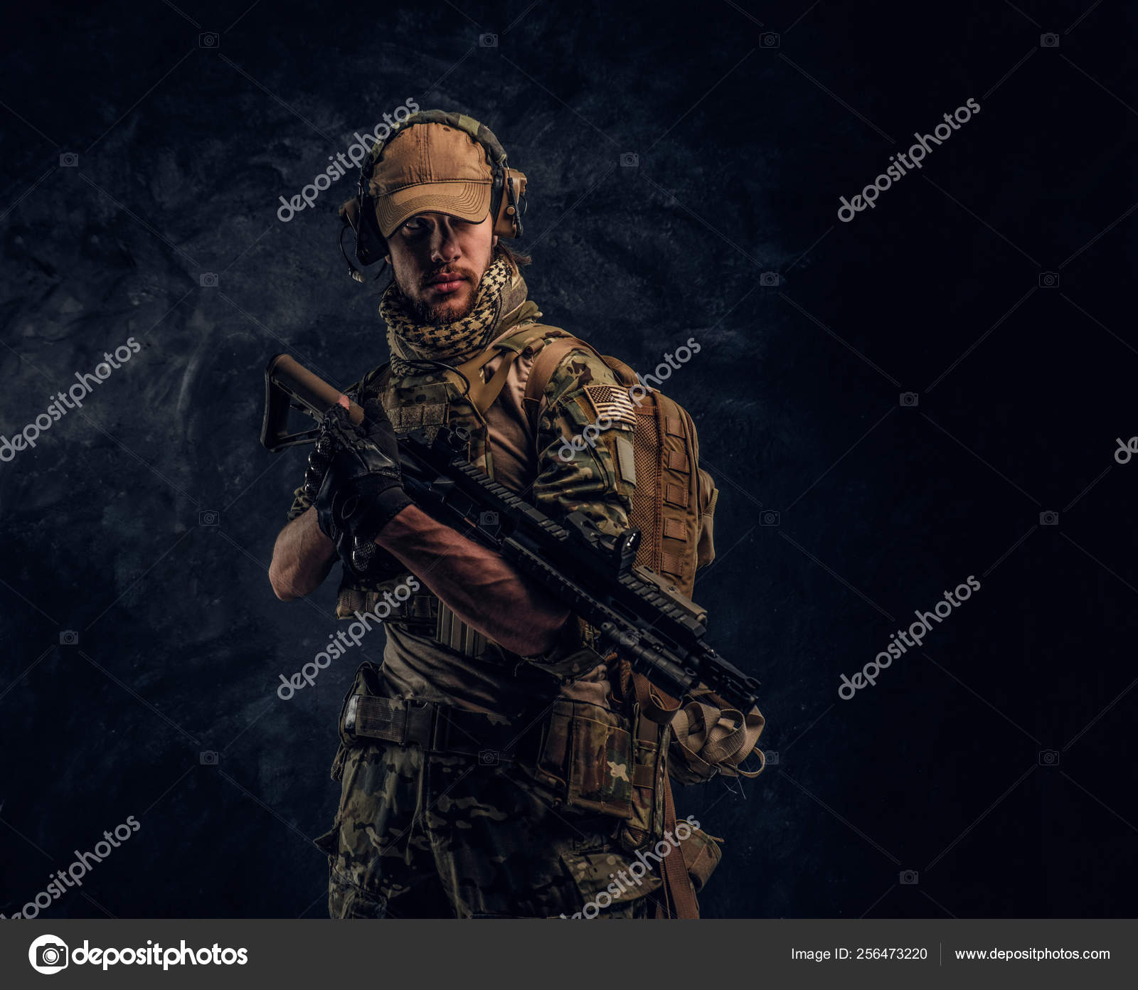 Fully equipped soldier in camouflage uniform holding an assault rifle ...