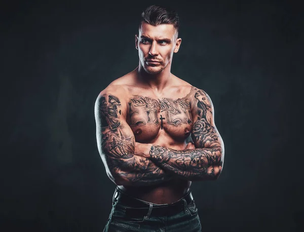 A muscular tattooed man on a dark background. Stock Photo by ©fxquadro ...