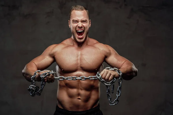 Shirtless guy with huge biceps and strong arms holding chains — Stock ...