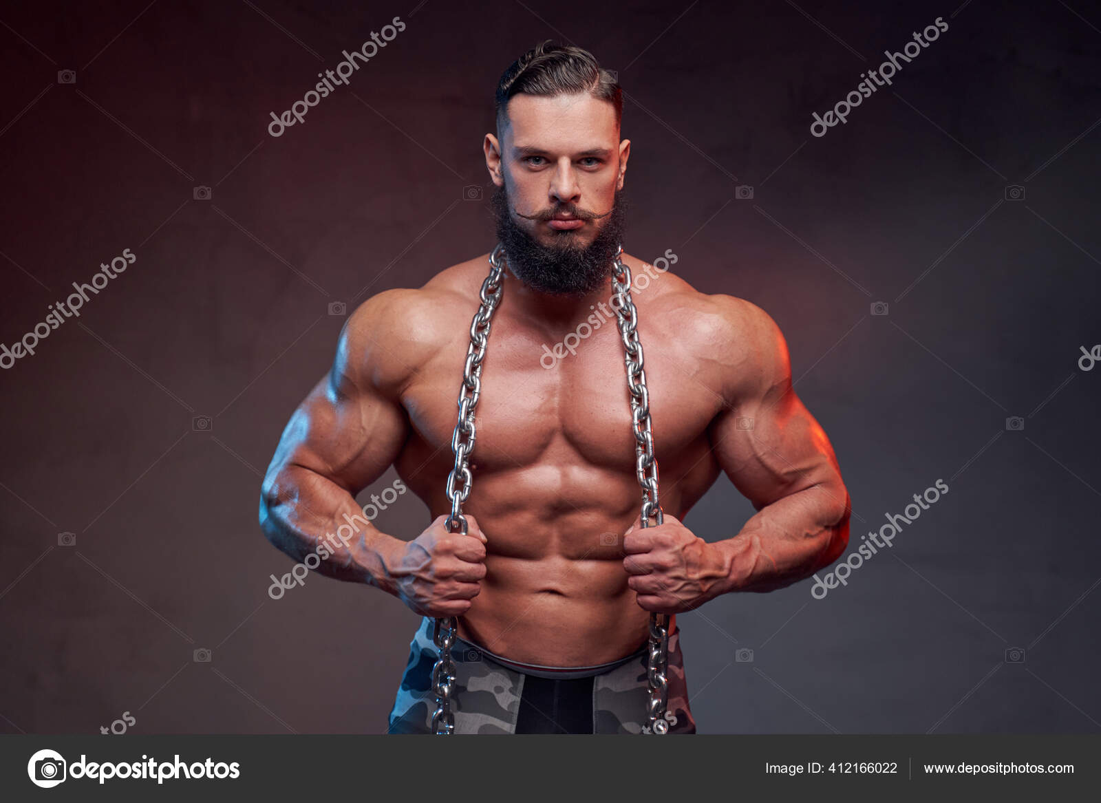 Bodybuilder with beard holding steel chains and posing Stock Photo by ...