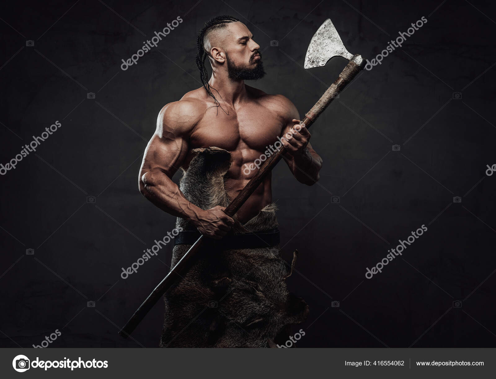Viking fighter posing looking at his axe in dark background Stock Photo ...