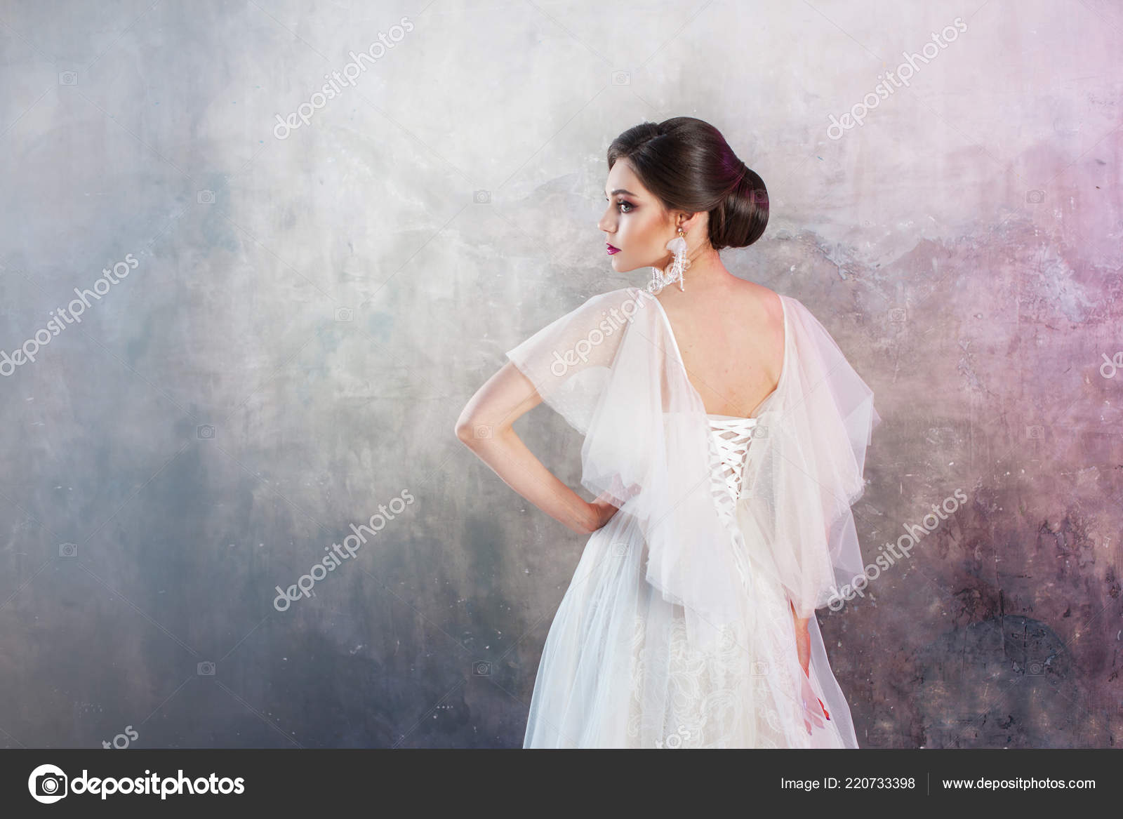 Back view of a young elegant brunette bride with a stylish hairstyle ...