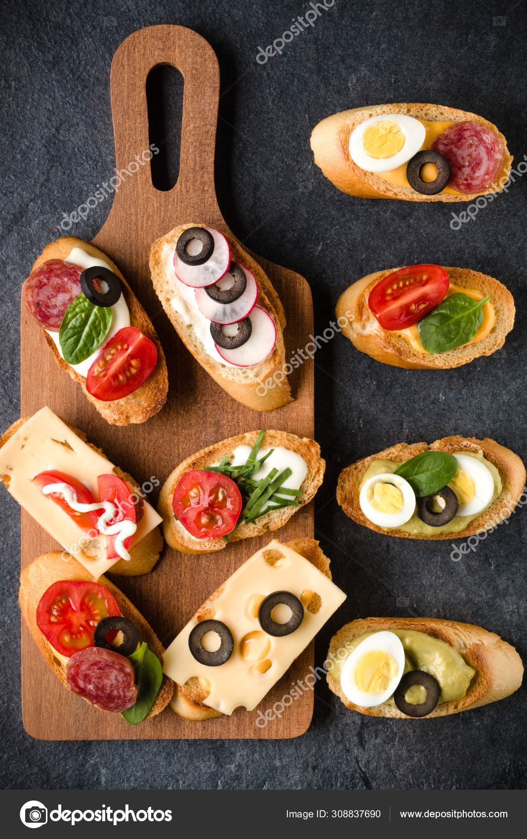 Open faced sandwich canape or crostini on a wooden serving board Stock ...