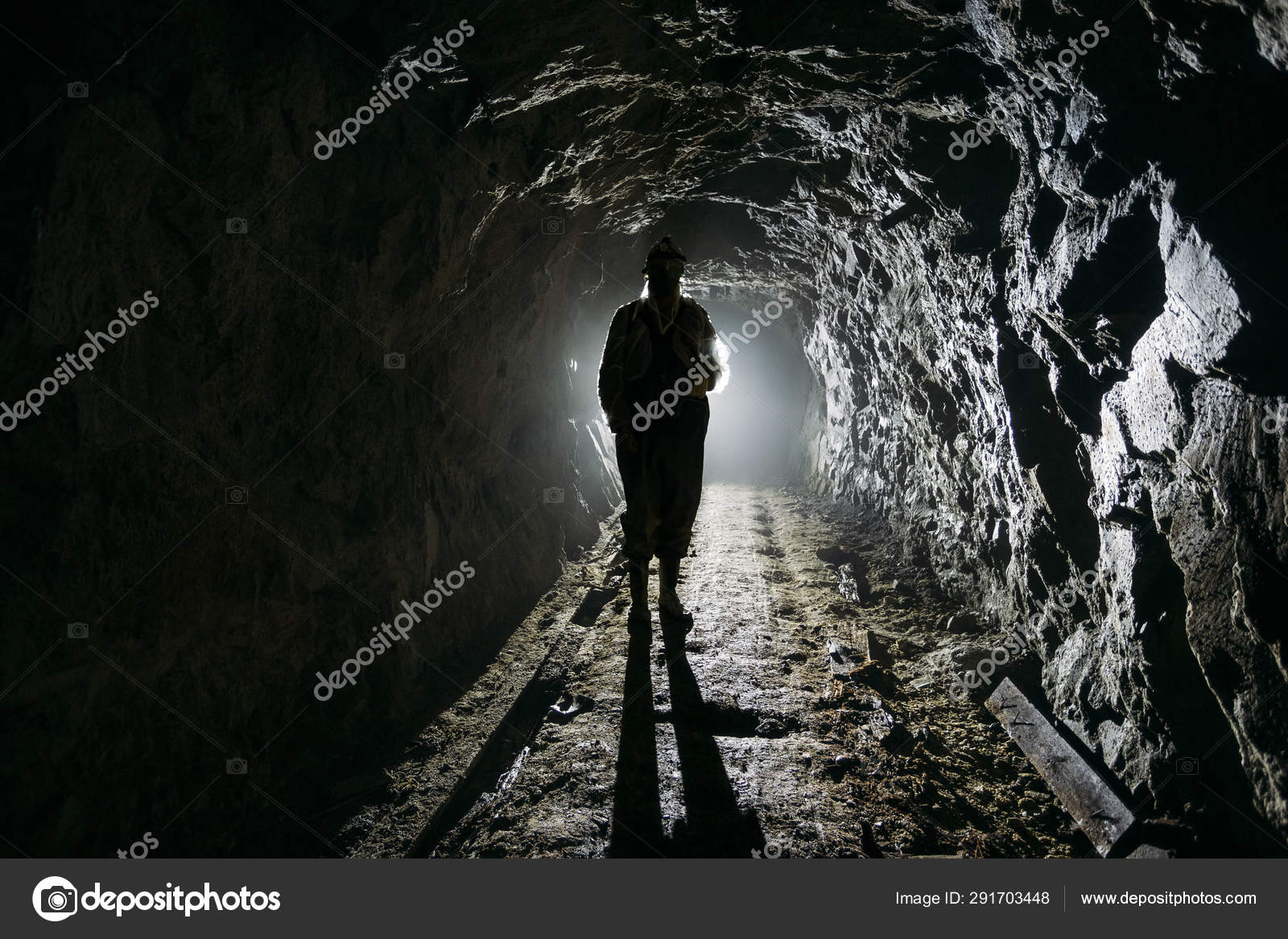 Creepy backlit human silhouette inside dark abandoned mine — Stock ...