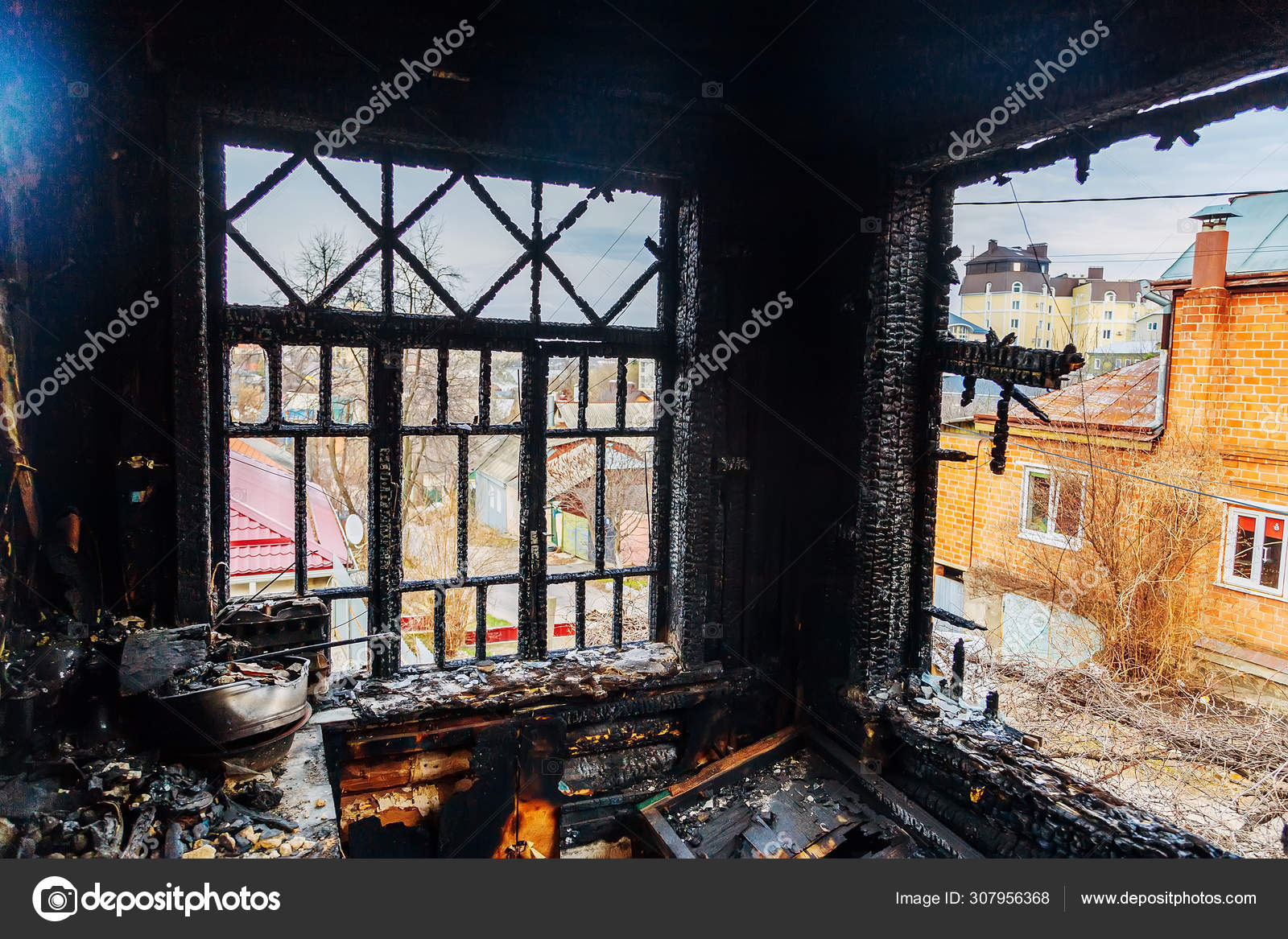 Burnt house interior. Burned kitchen, remains of furniture in black ...