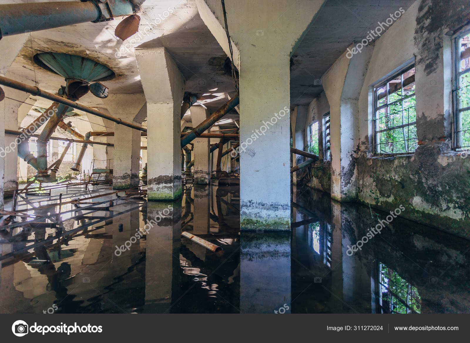 Flooded abandoned ruined flour mill factory. Old rusty pipes in Stock ...