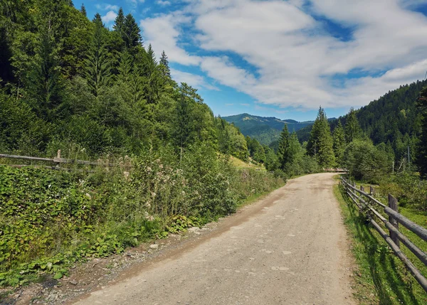 composite landscape. fence near the cross road on hillside meadow in ...