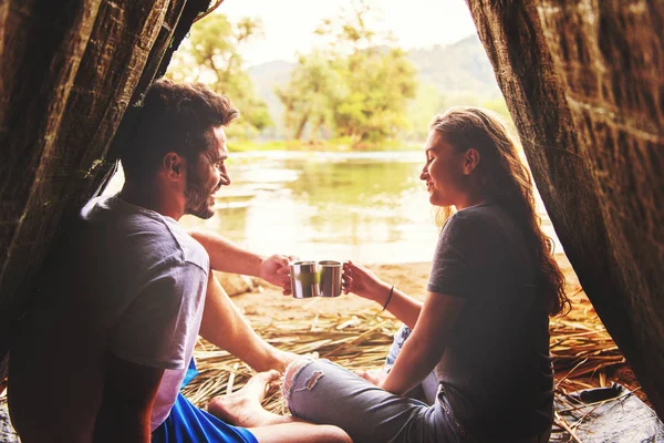 couple in love traveling and spending time together in straw tent while ...