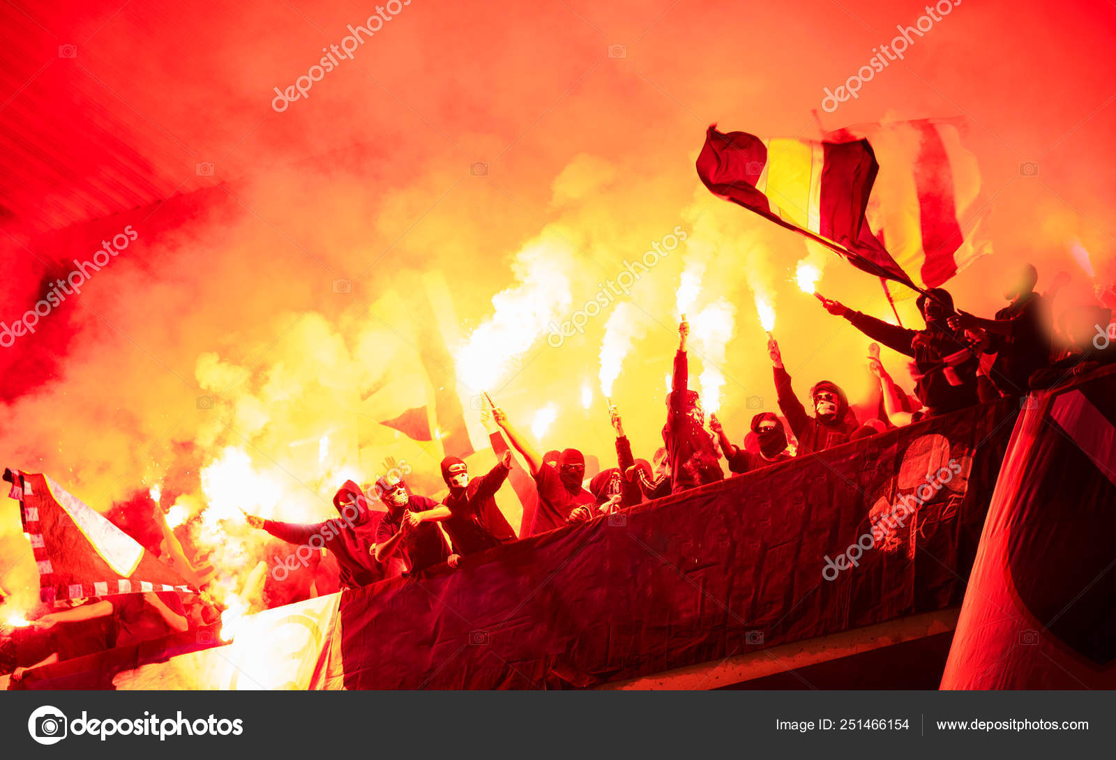 Football hooligans with mask holding torches in fire — Stock Editorial ...
