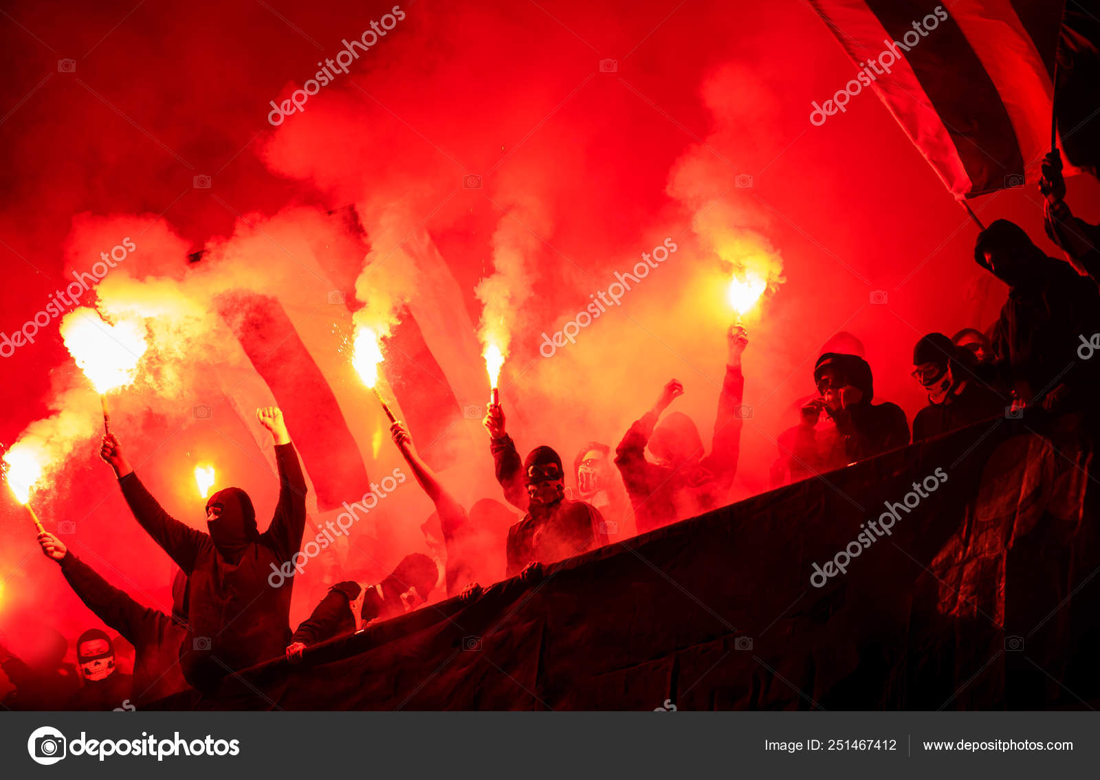Football hooligans with mask holding torches in fire — Stock Editorial ...