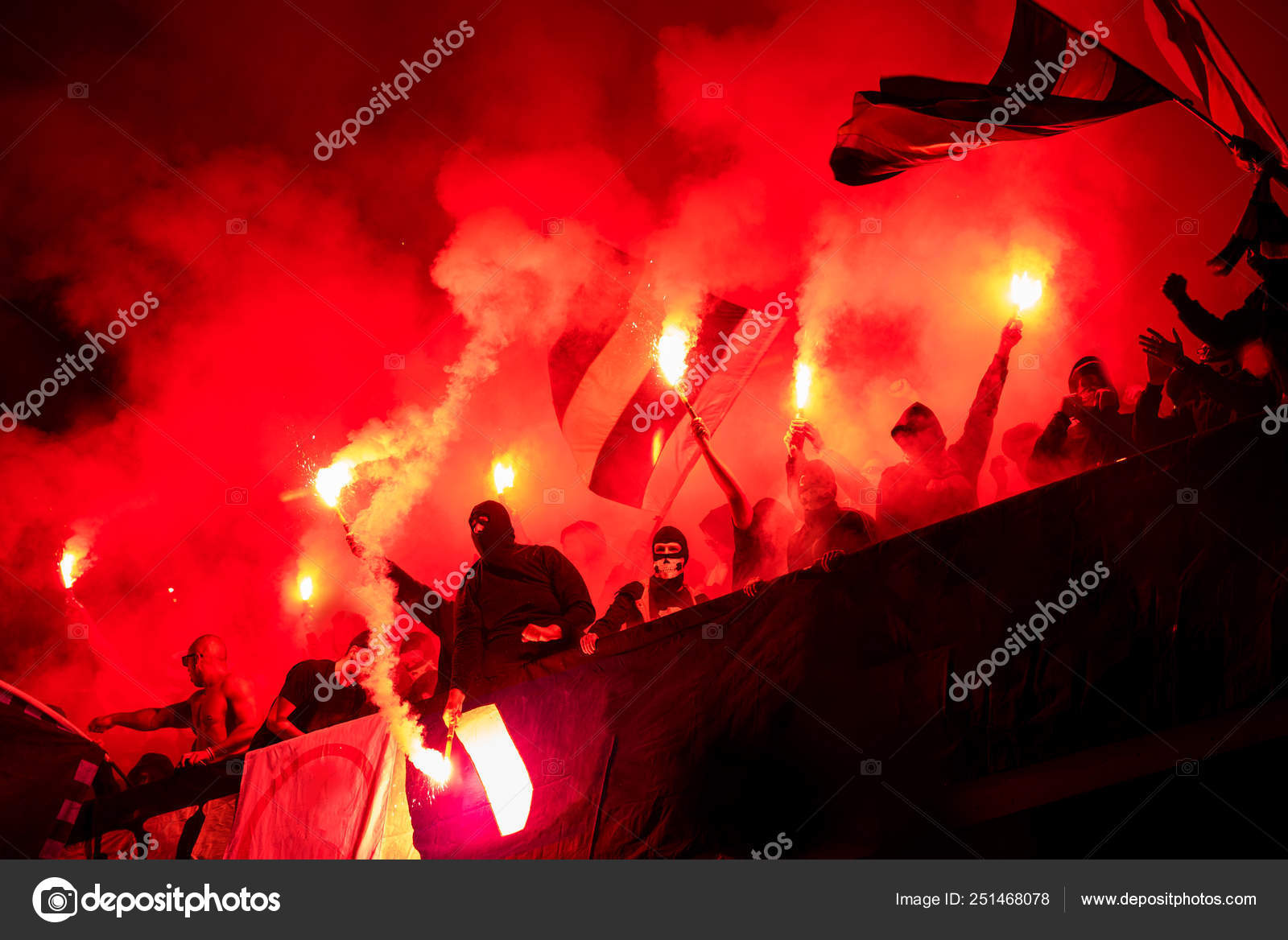 Football hooligans with mask holding torches in fire — Stock Editorial ...