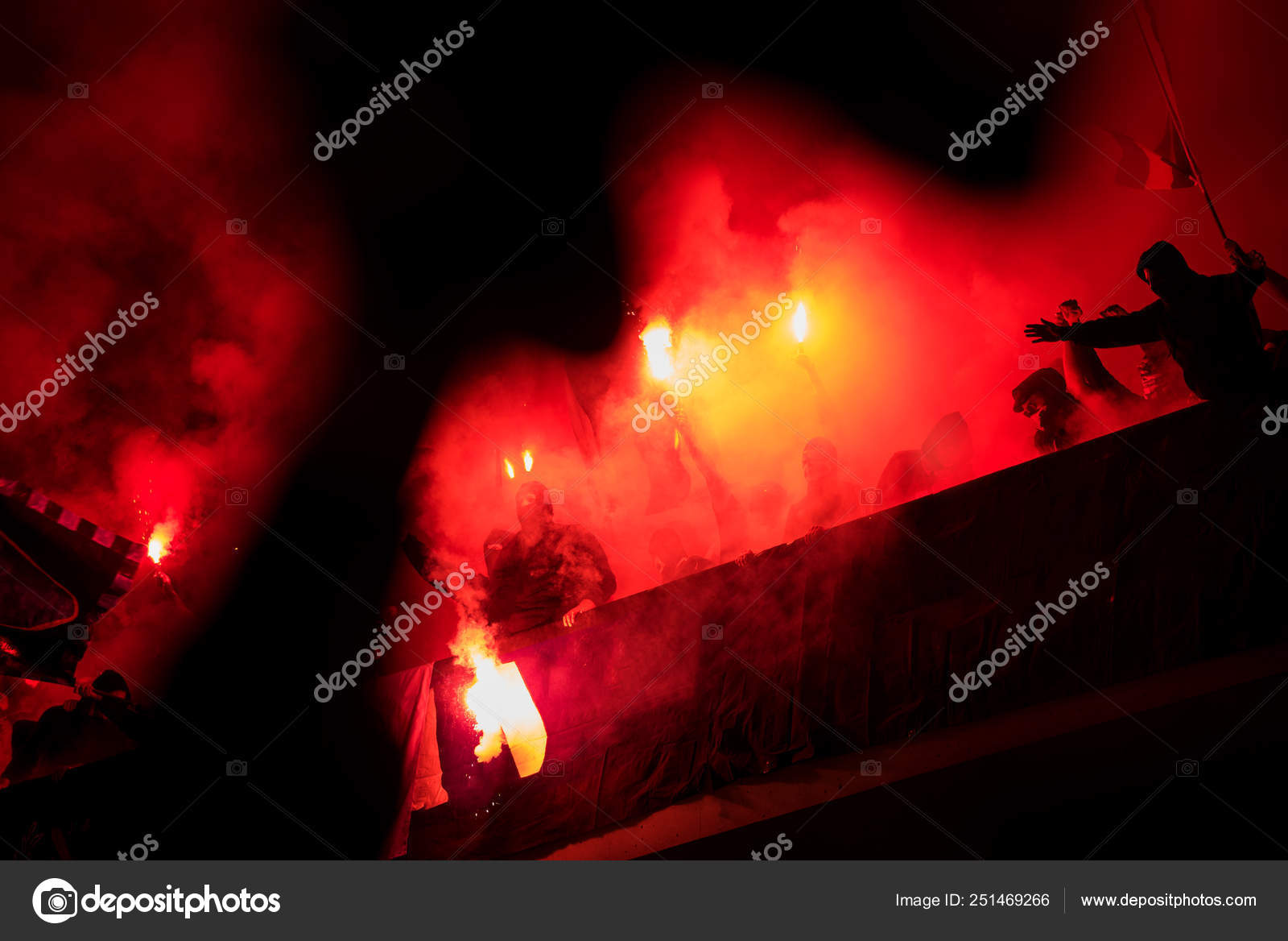 Football hooligans with mask holding torches in fire — Stock Editorial ...