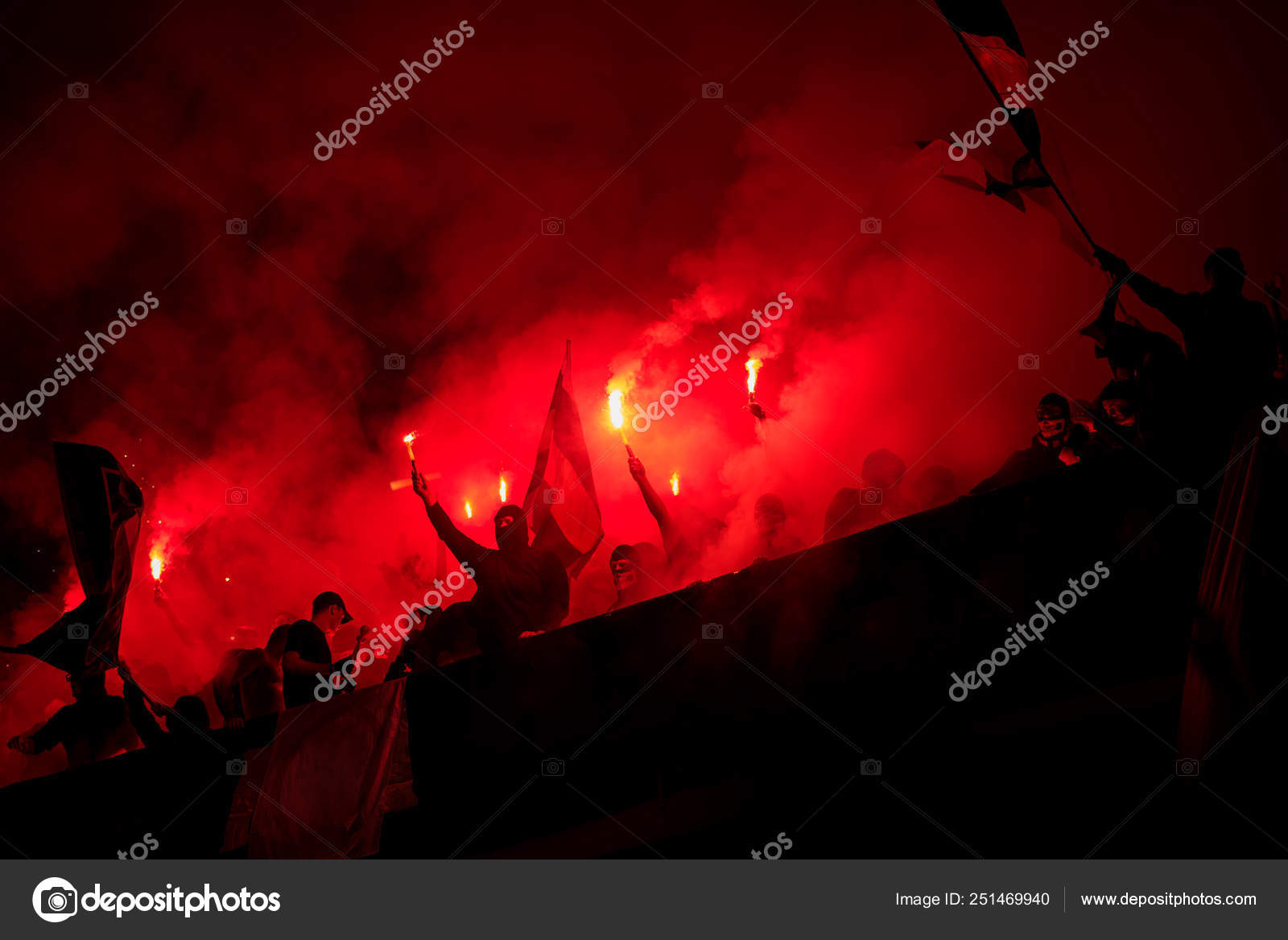 Football hooligans with mask holding torches in fire — Stock Editorial ...