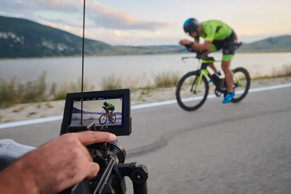 cinematographer with professional cinema camera taking sport action ...