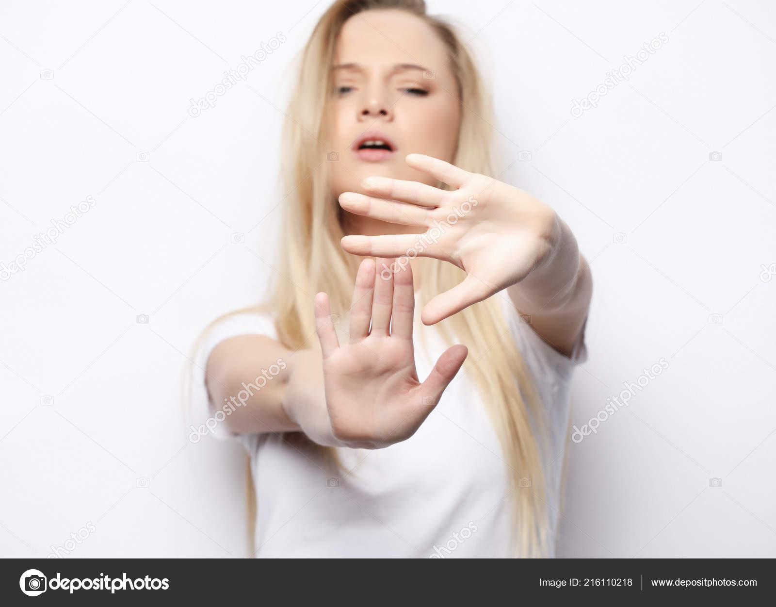 Body language. Disgusted stressed out angry young blond woman posing at ...