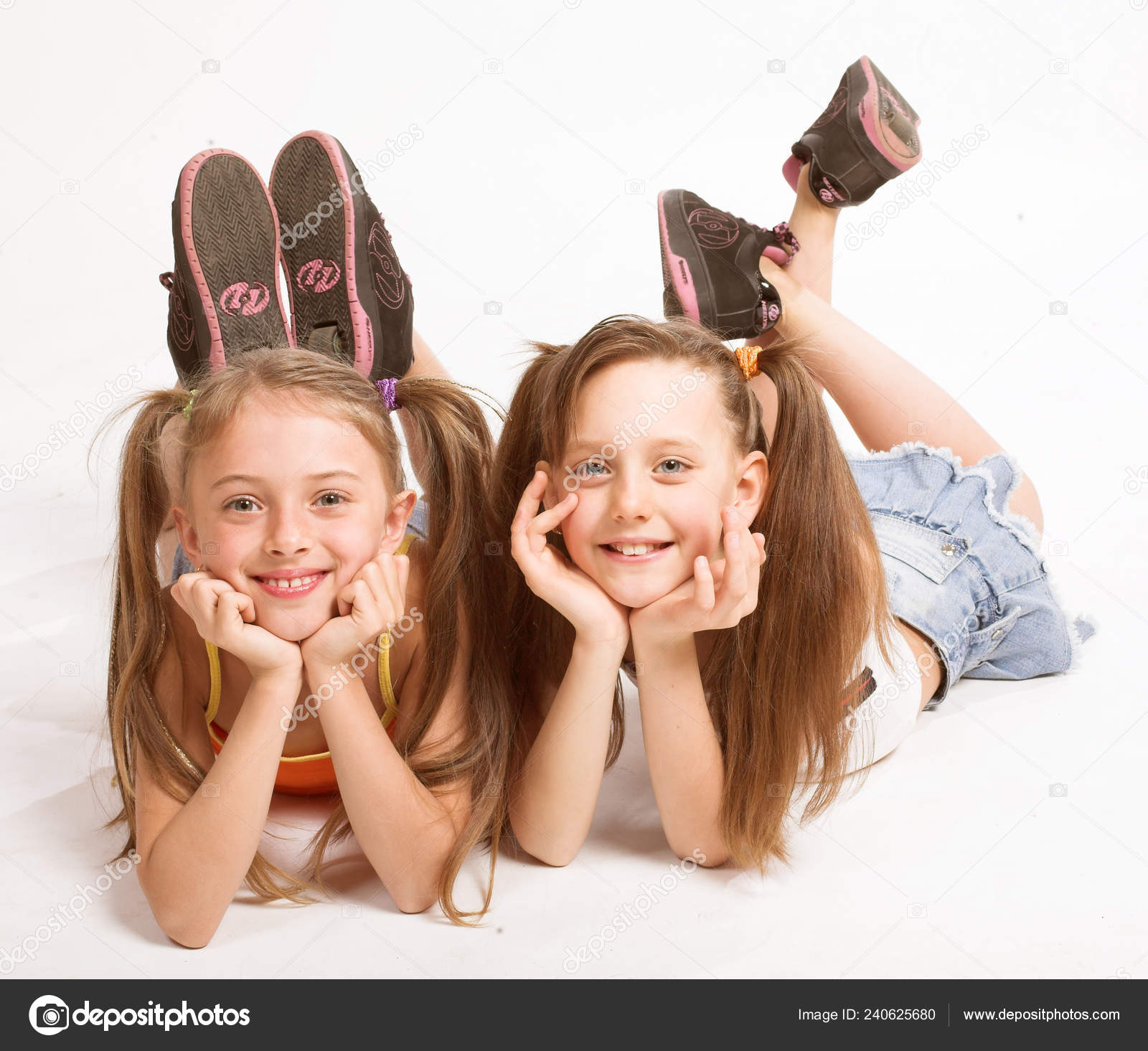 Two beautiful girls laying on white Stock Photo by ©kanareva 240625680
