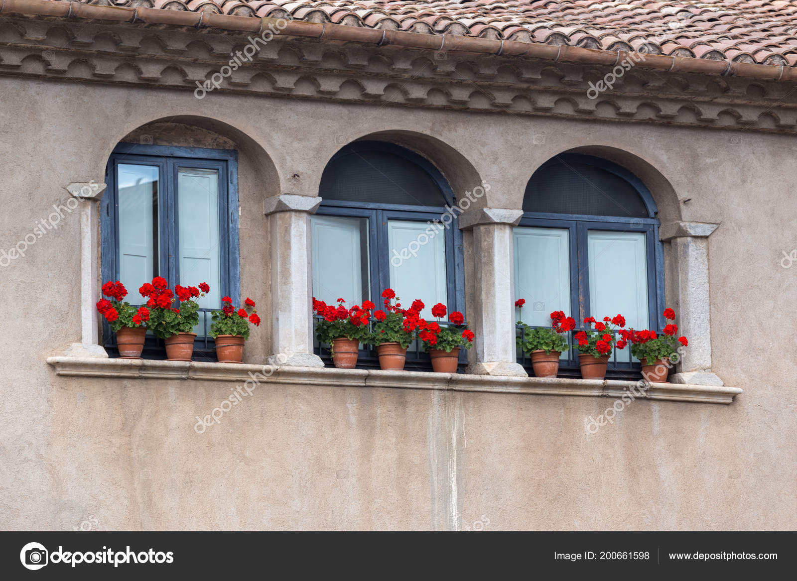 Bonitas ventanas con flores de geranio en un pueblo español Gerona ...