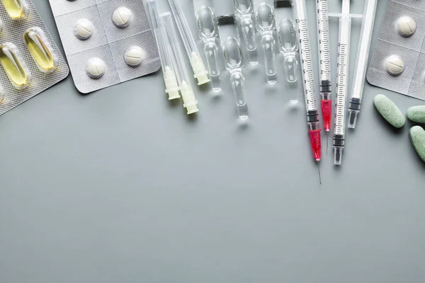 Medications in tablets and injections on a gray background - Stock ...