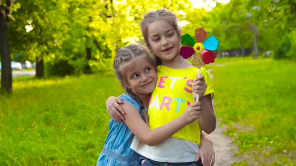 Two sisters girls holding colorful pinwheel — Stock Video © Dmitroza ...