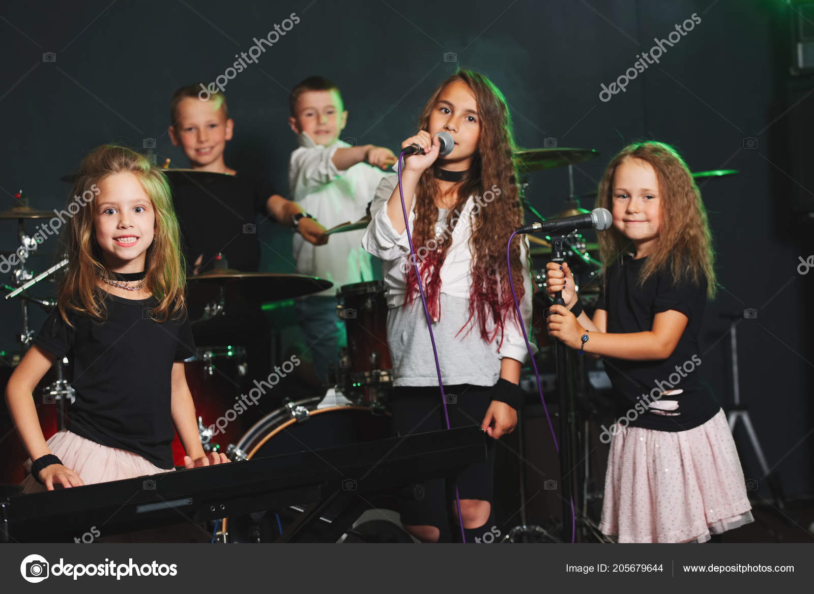 Happy children singing and playing music Stock Photo by ©ababaka 205679644
