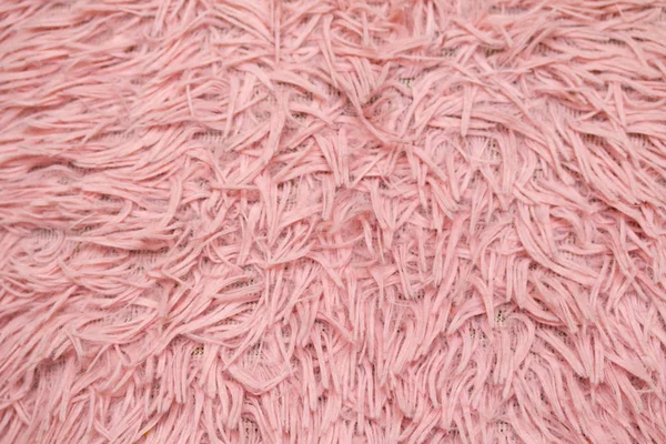 fur rug. Pink natural wool with twists texture background. Cotton wool ...
