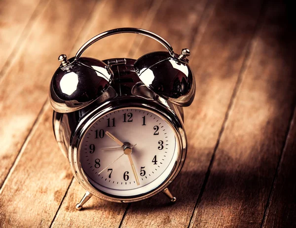 Retro alarm clock on a table. Stock Photo by ©massonforstock 38249319