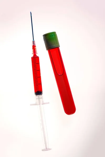 Syringe with red injection Stock Photos, Royalty Free Syringe with red ...